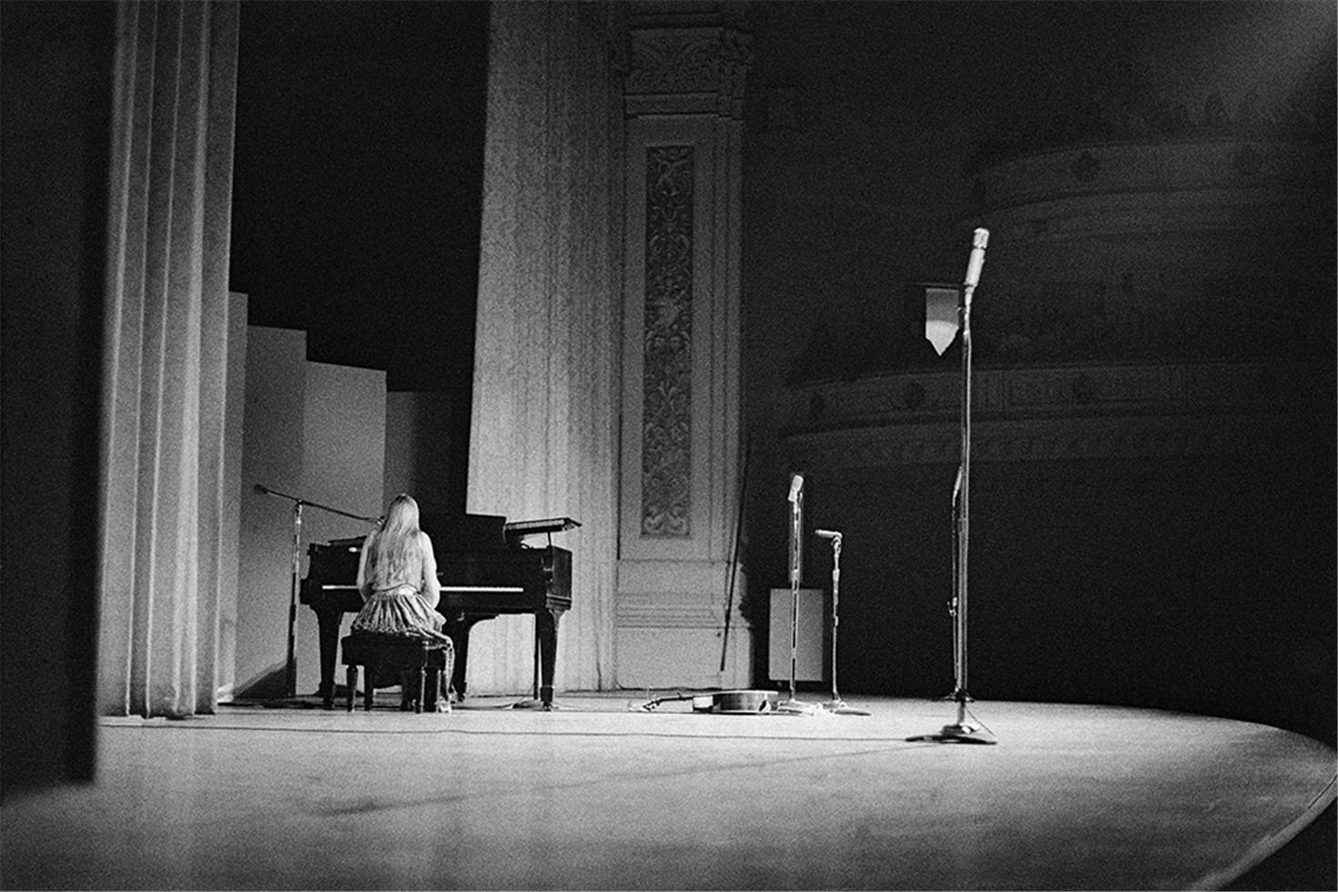 Joni Mitchell, playing piano onstage at her first concert at Carnegie